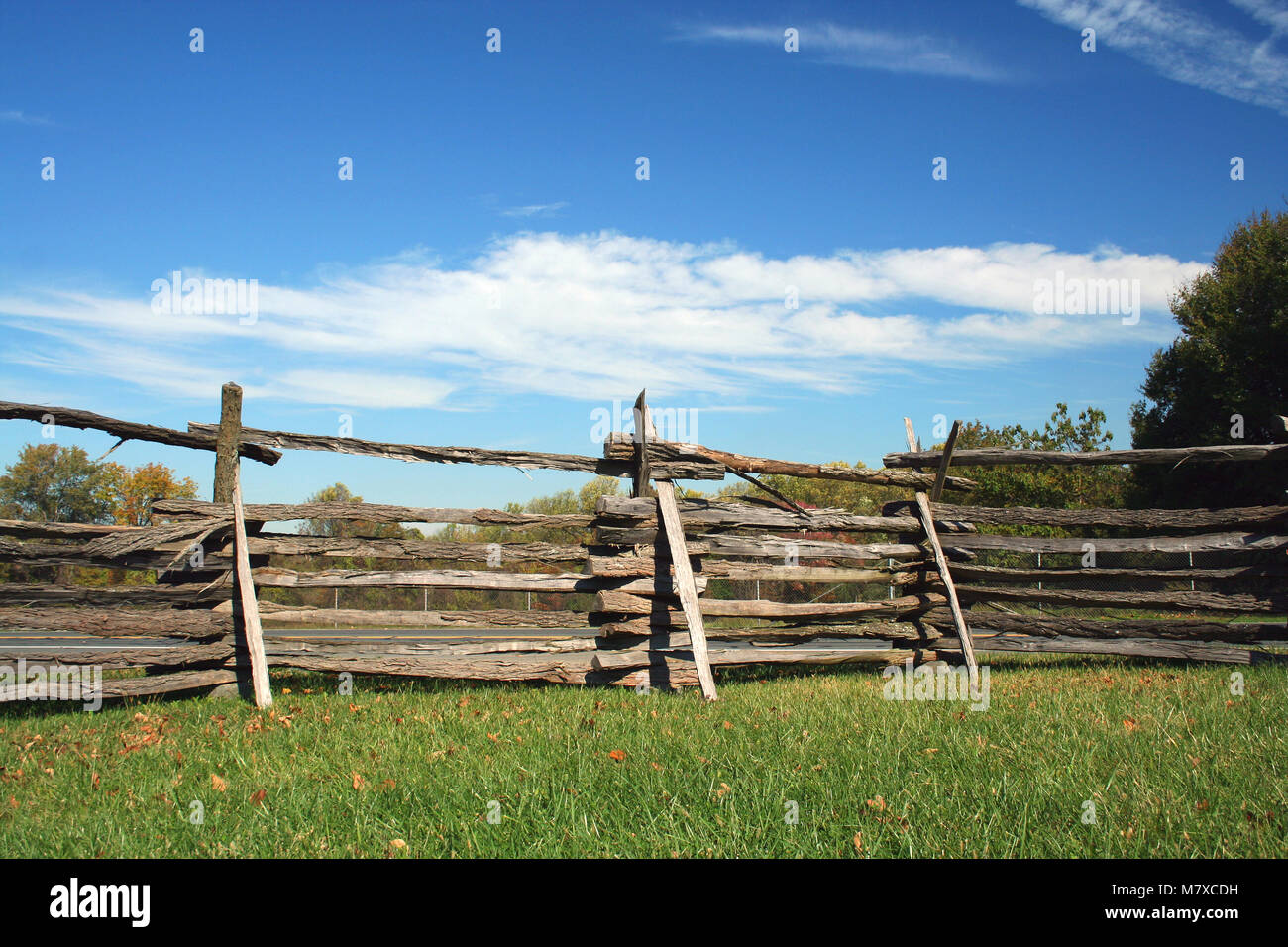 A Stacked wood fence against blue sky Stock Photo - Alamy