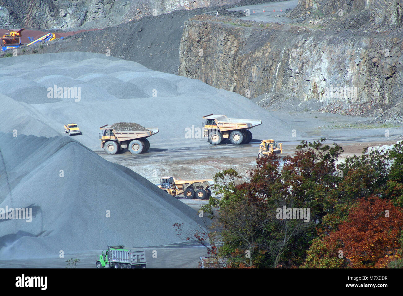 A Rock Quarry with equipment and trucks Stock Photo - Alamy
