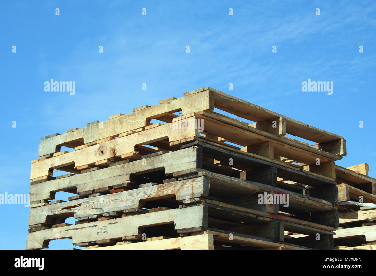 Stacked Pallets against a blue sky Stock Photo - Alamy