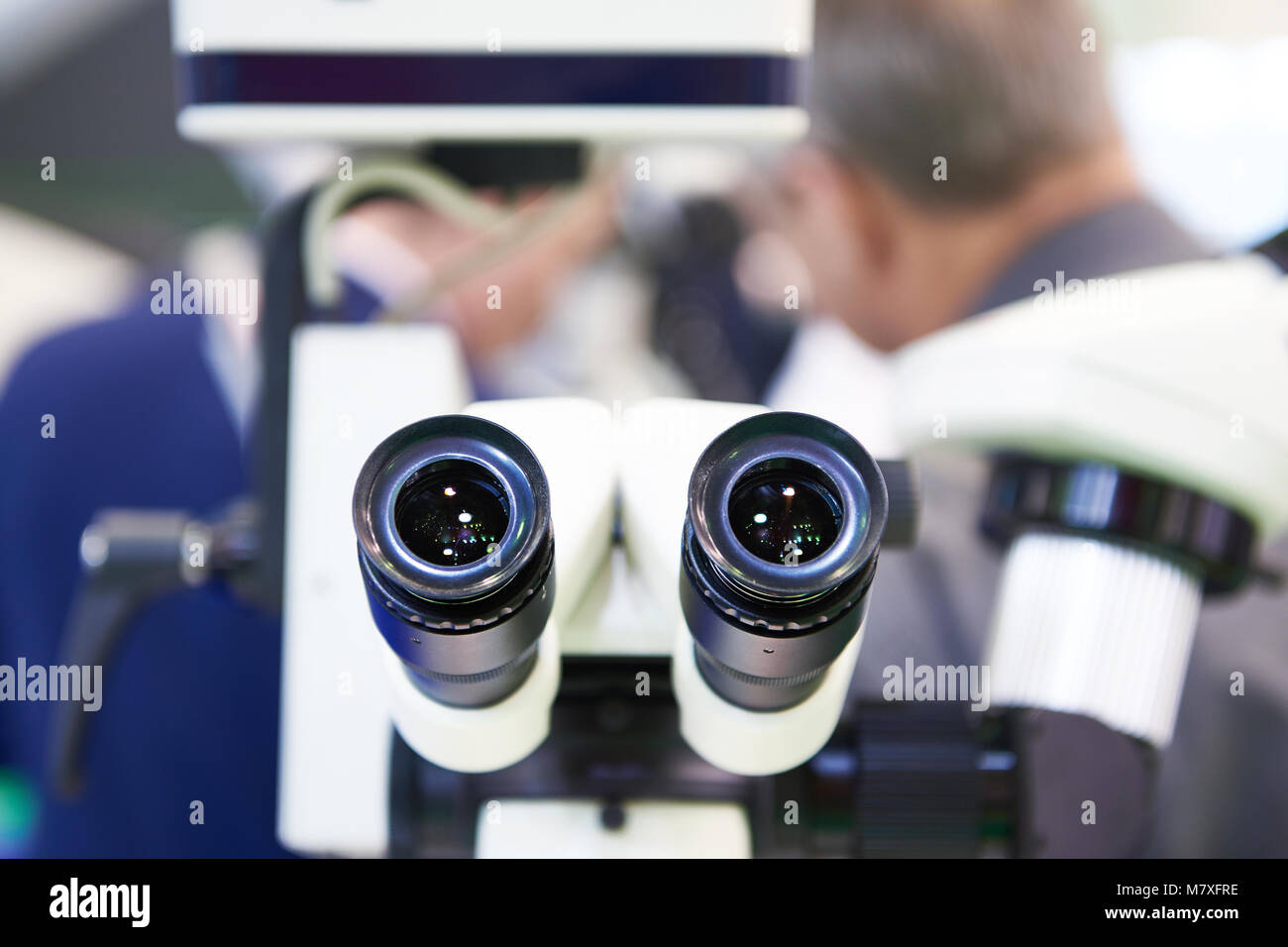 Microscope eyepieces on blur background Stock Photo - Alamy