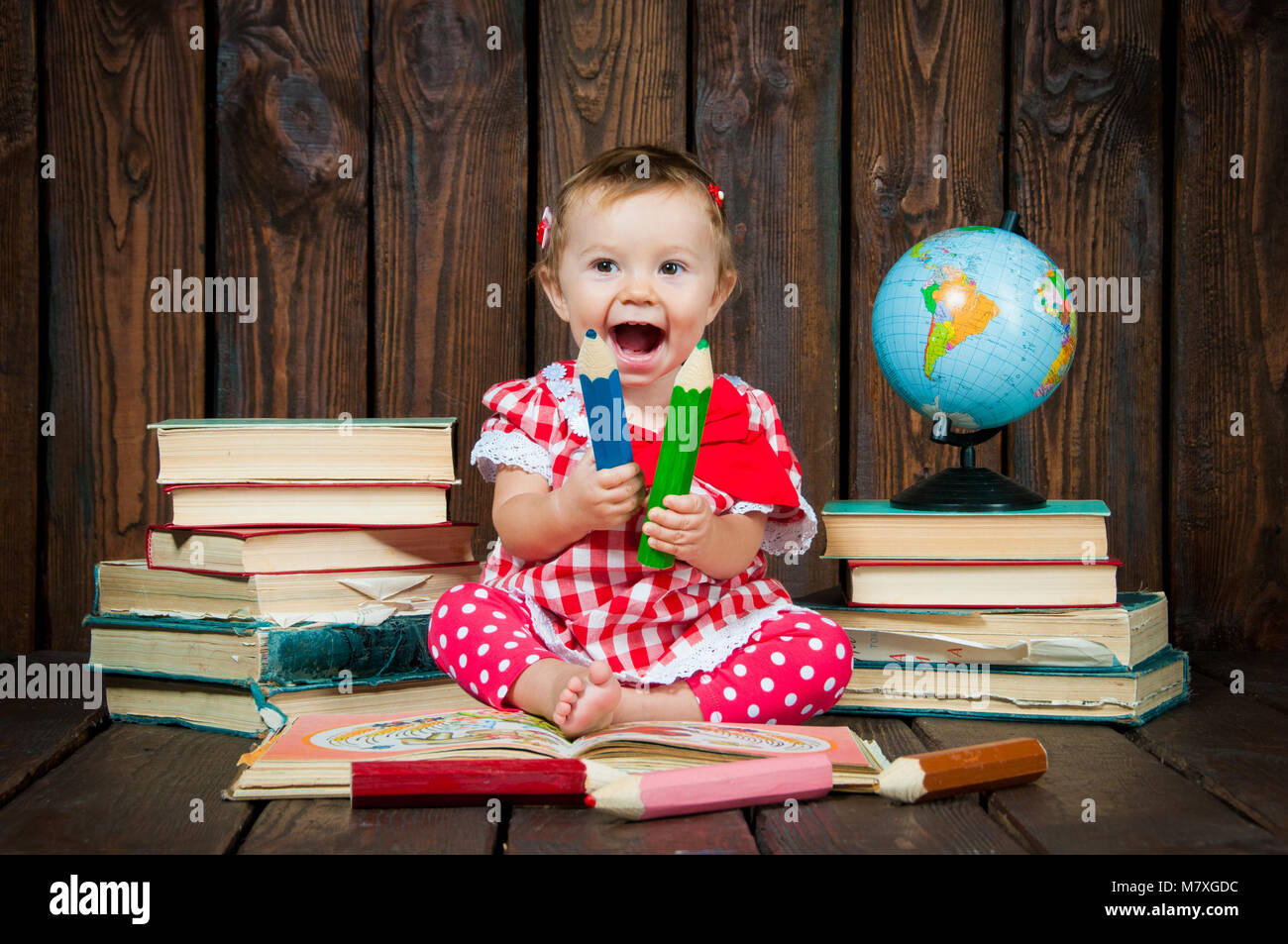 Happy a nice little girl with glasses and pencils against the ...
