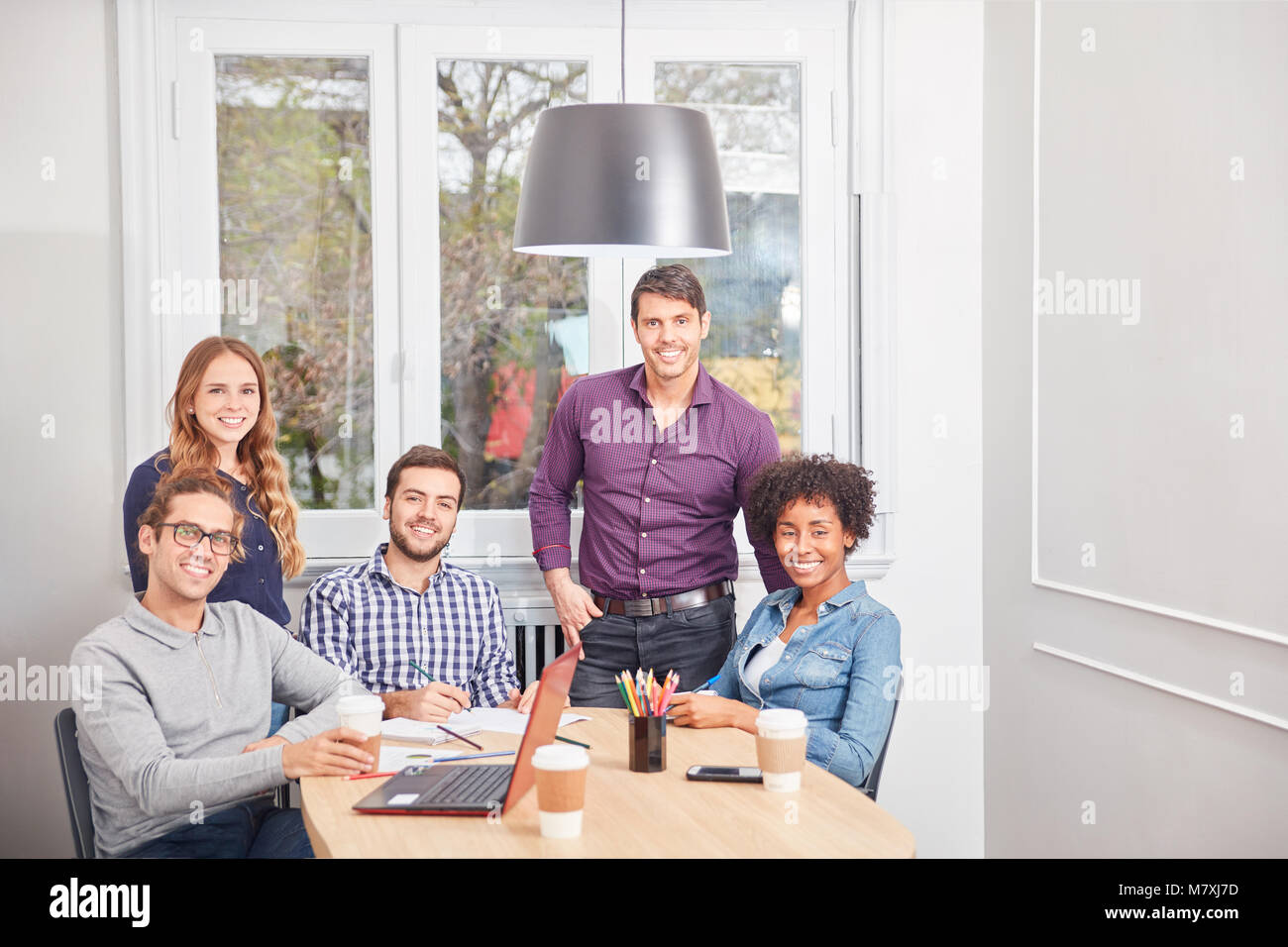 Group of young students as a multicultural business team in the ...