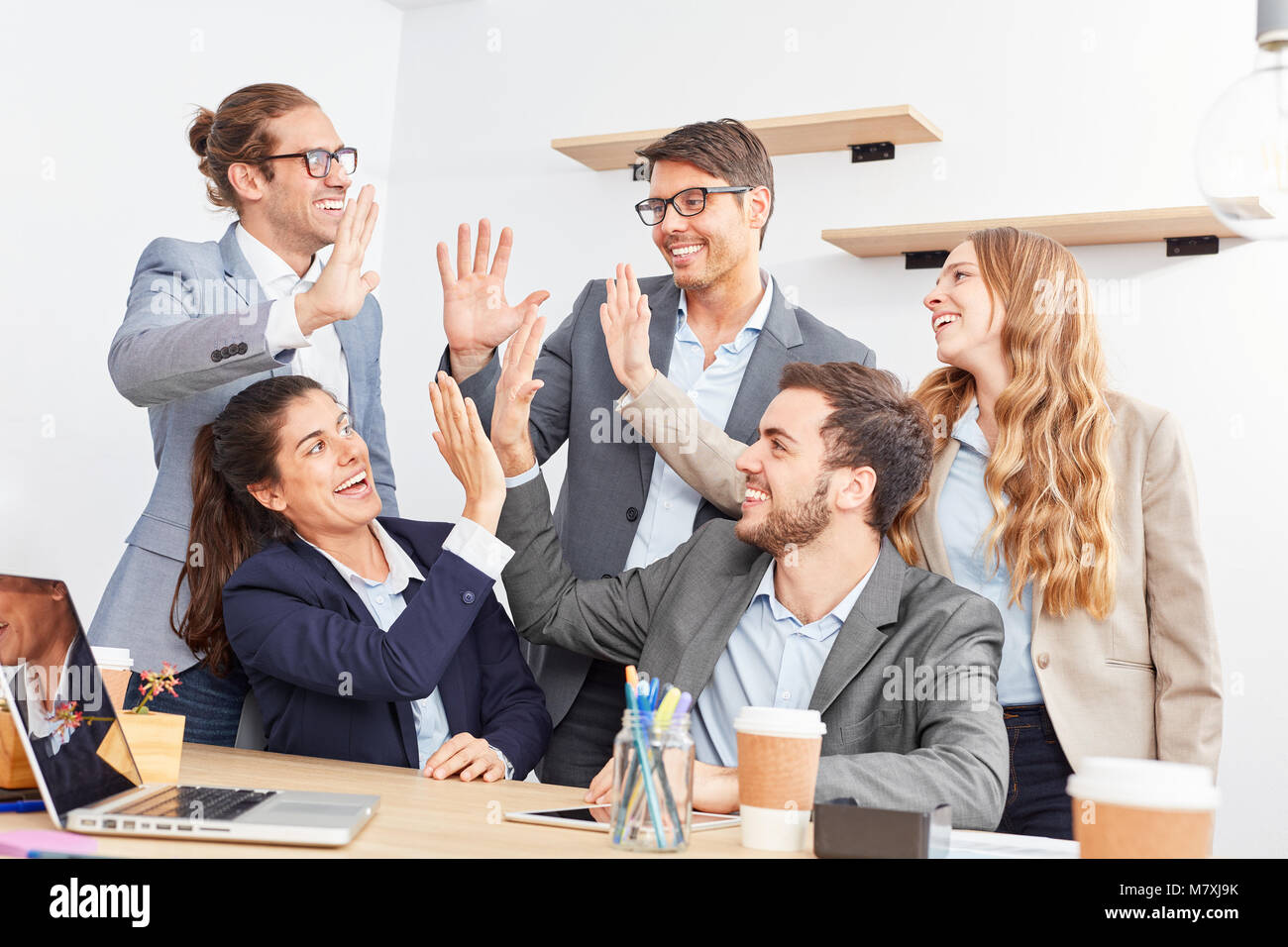 Creative start-up team celebrates success and team spirit with the High ...