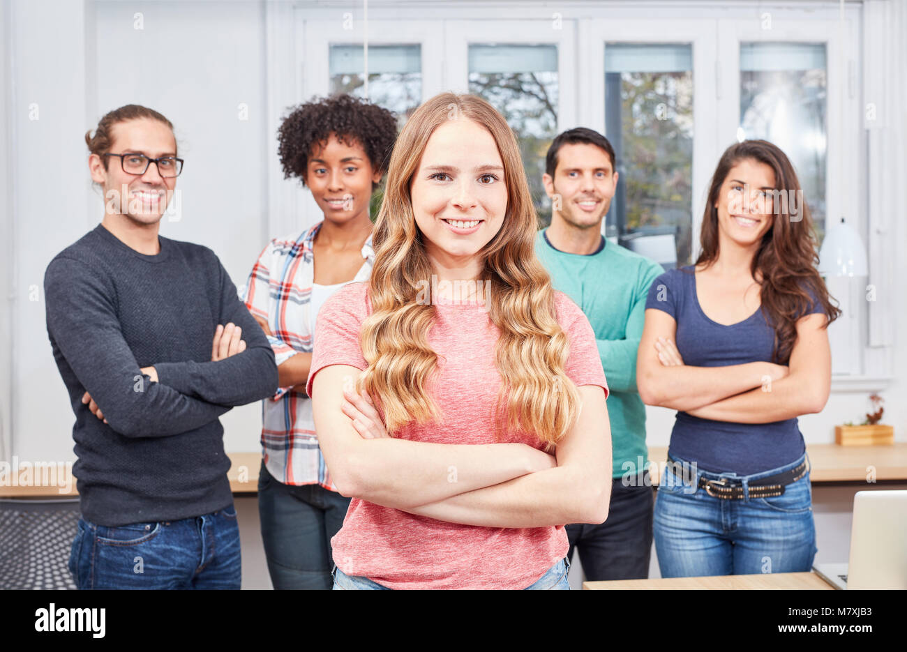 Young woman as apprentice or trainee in internship in front of her ...
