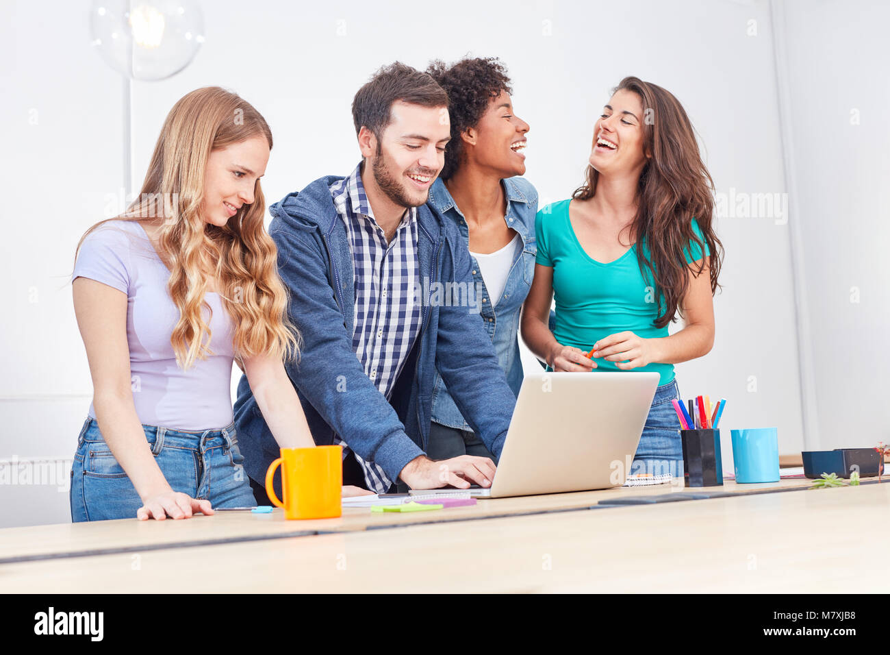 Group of students working on a computer hi-res stock photography and ...