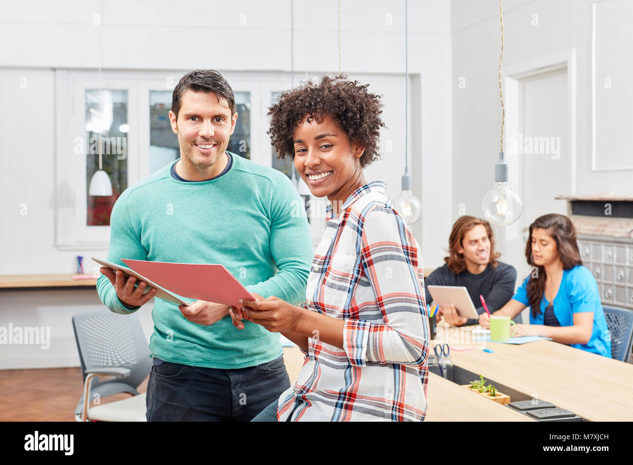 Successful multicultural start-up founder in coworking office with team ...