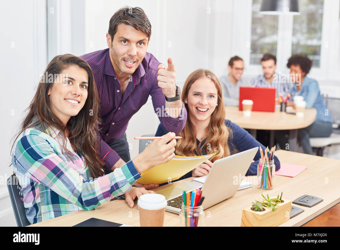 Successful start-up founder plans with his team in the coworking office ...