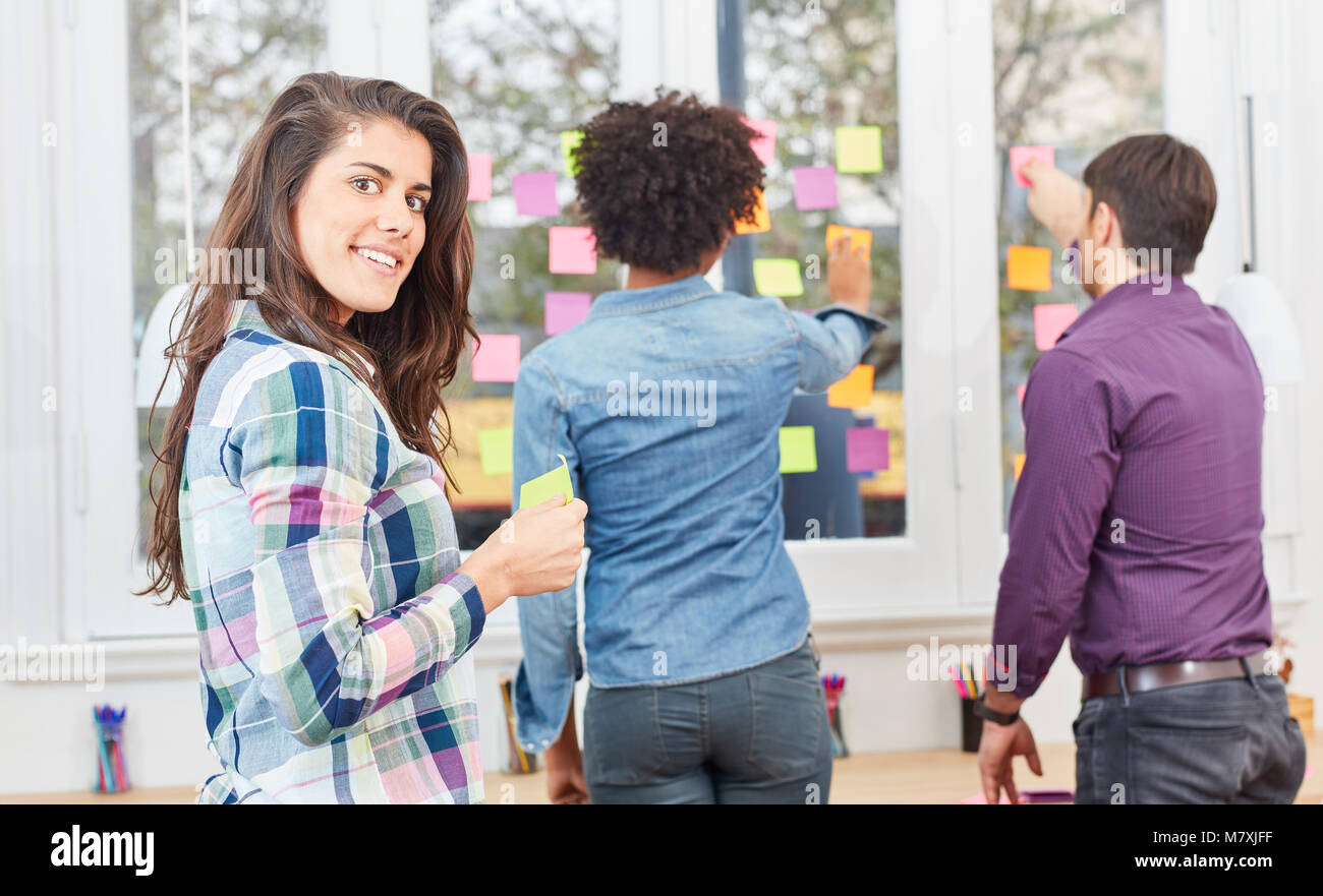 Group of young business people in business start-up doing a ...