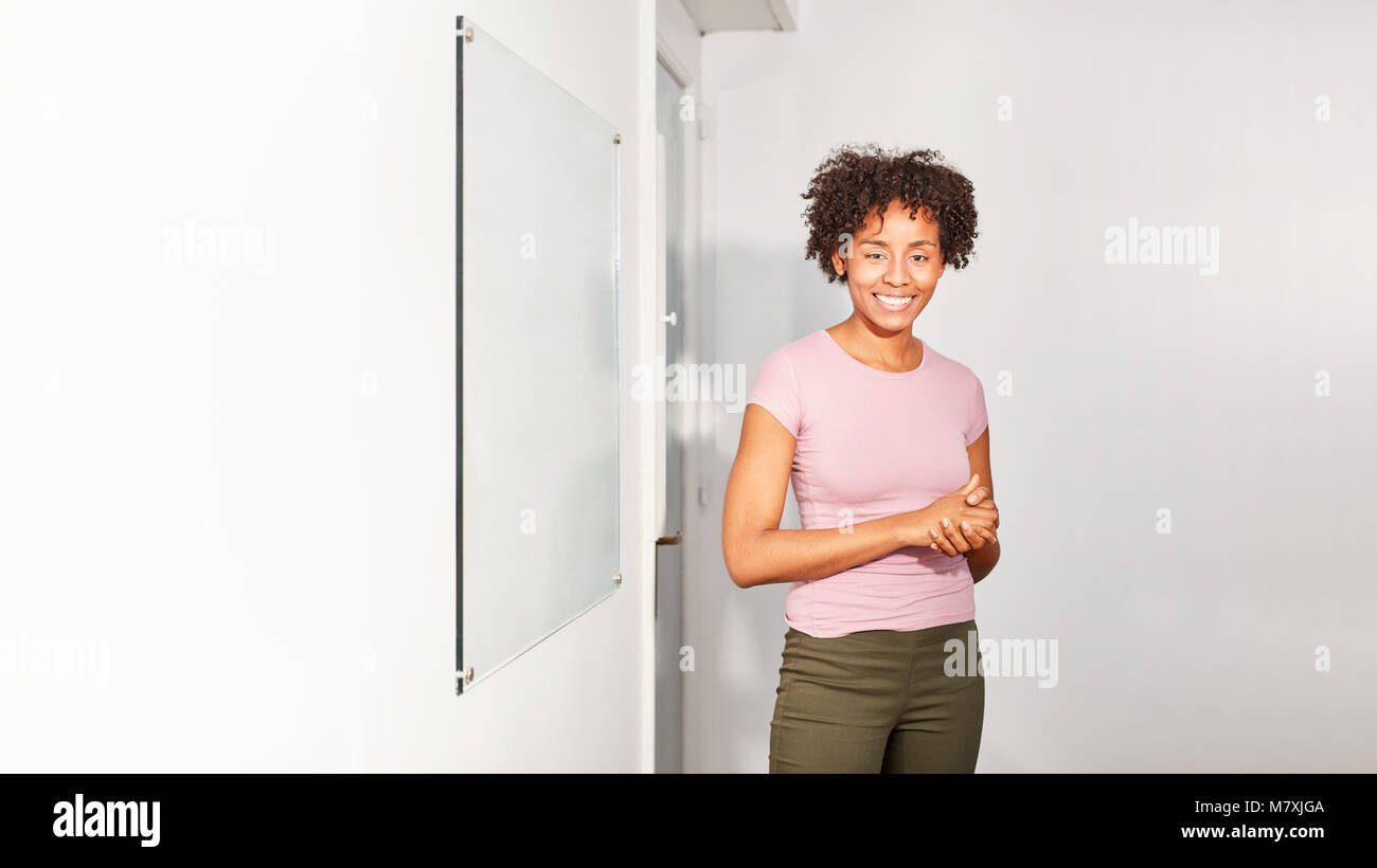 Young multicultural student as trainee or trainee is smiling happily ...