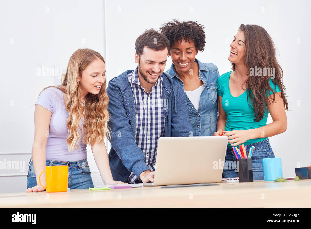 Young students have fun together in the computer workshop training ...