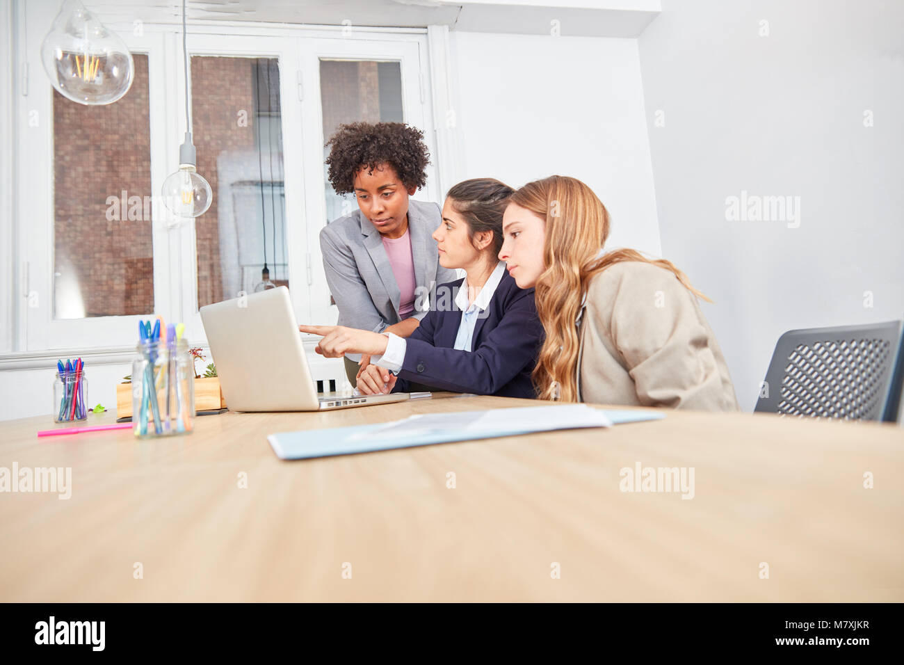 Business women in a training on laptop Computer in the office with ...