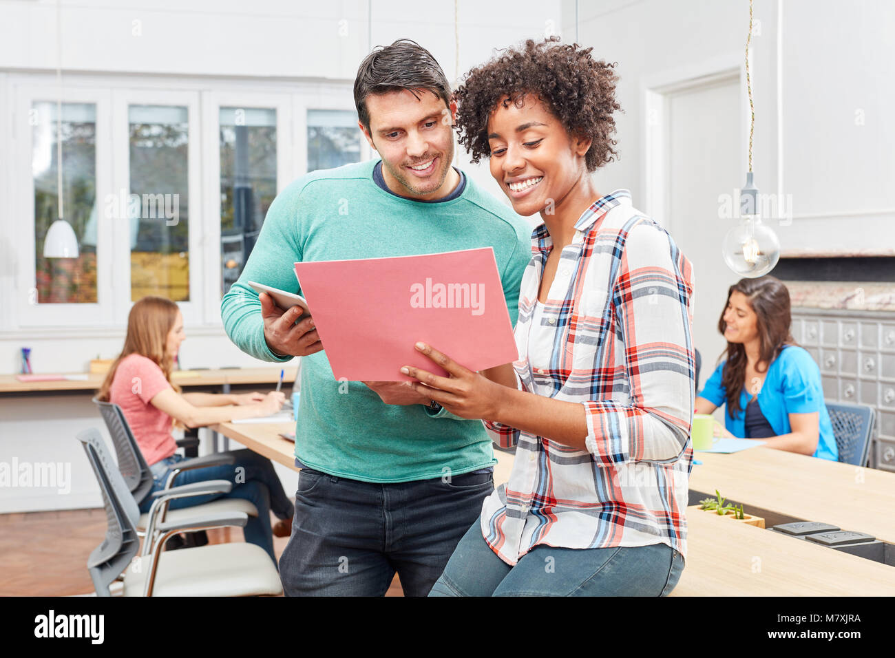 Two students as start-up founders discuss an idea in the coworking ...