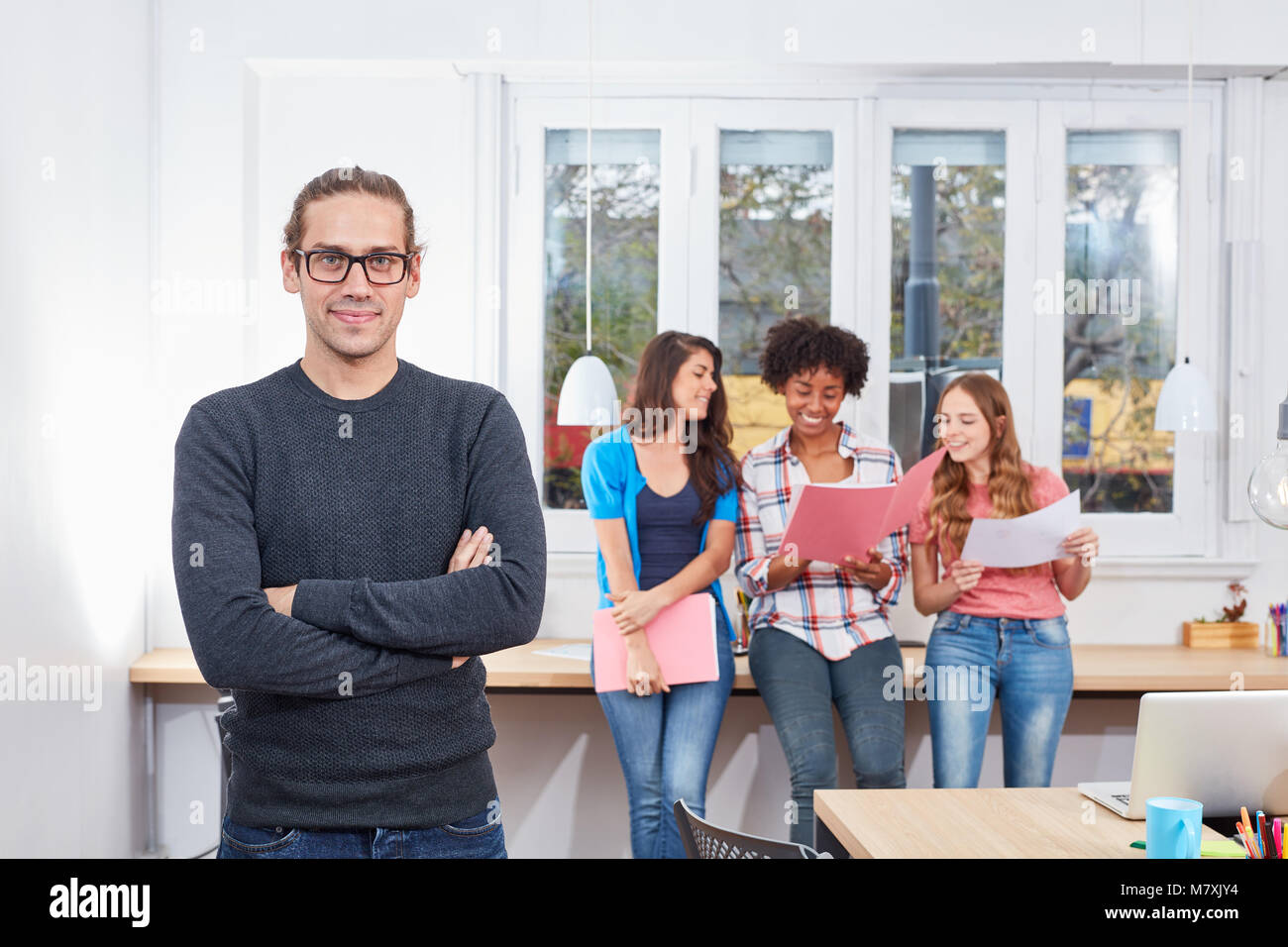 Student as a young entrepreneur in front of his start-up team in the ...