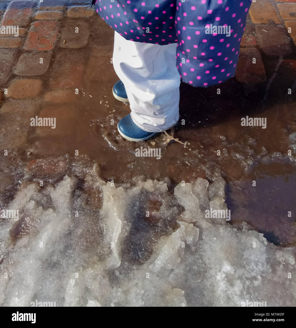 kid in puddle Stock Photo - Alamy