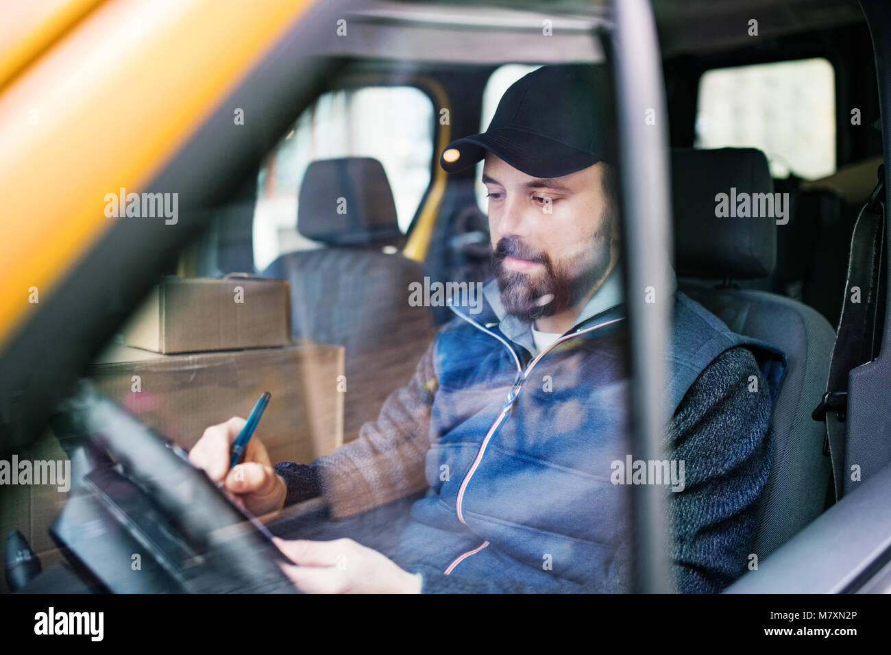 Delivery man delivering parcel box to recipient - courier service ...