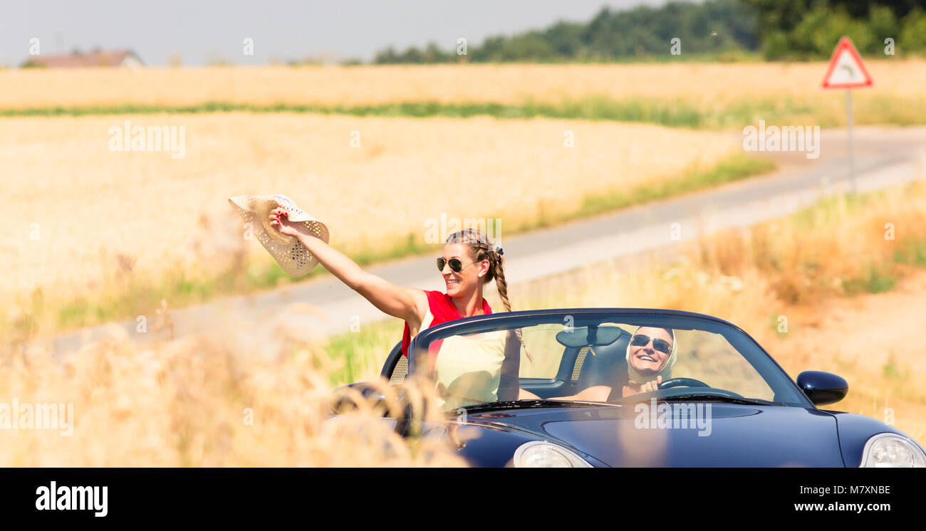 friends having summer joyride in convertible car Stock Photo - Alamy