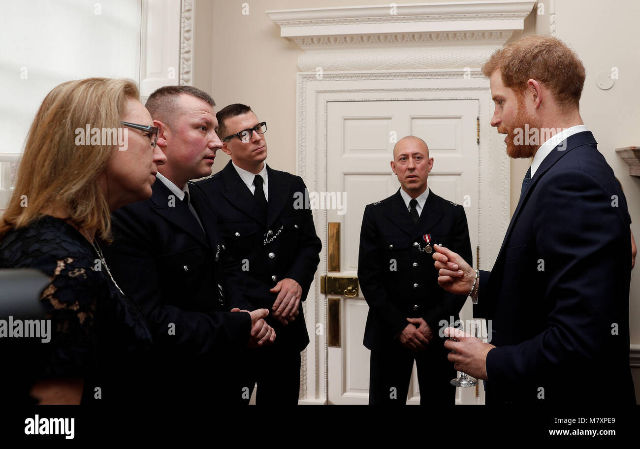 Prince Harry (right) meets police officers, staff and volunteers ...
