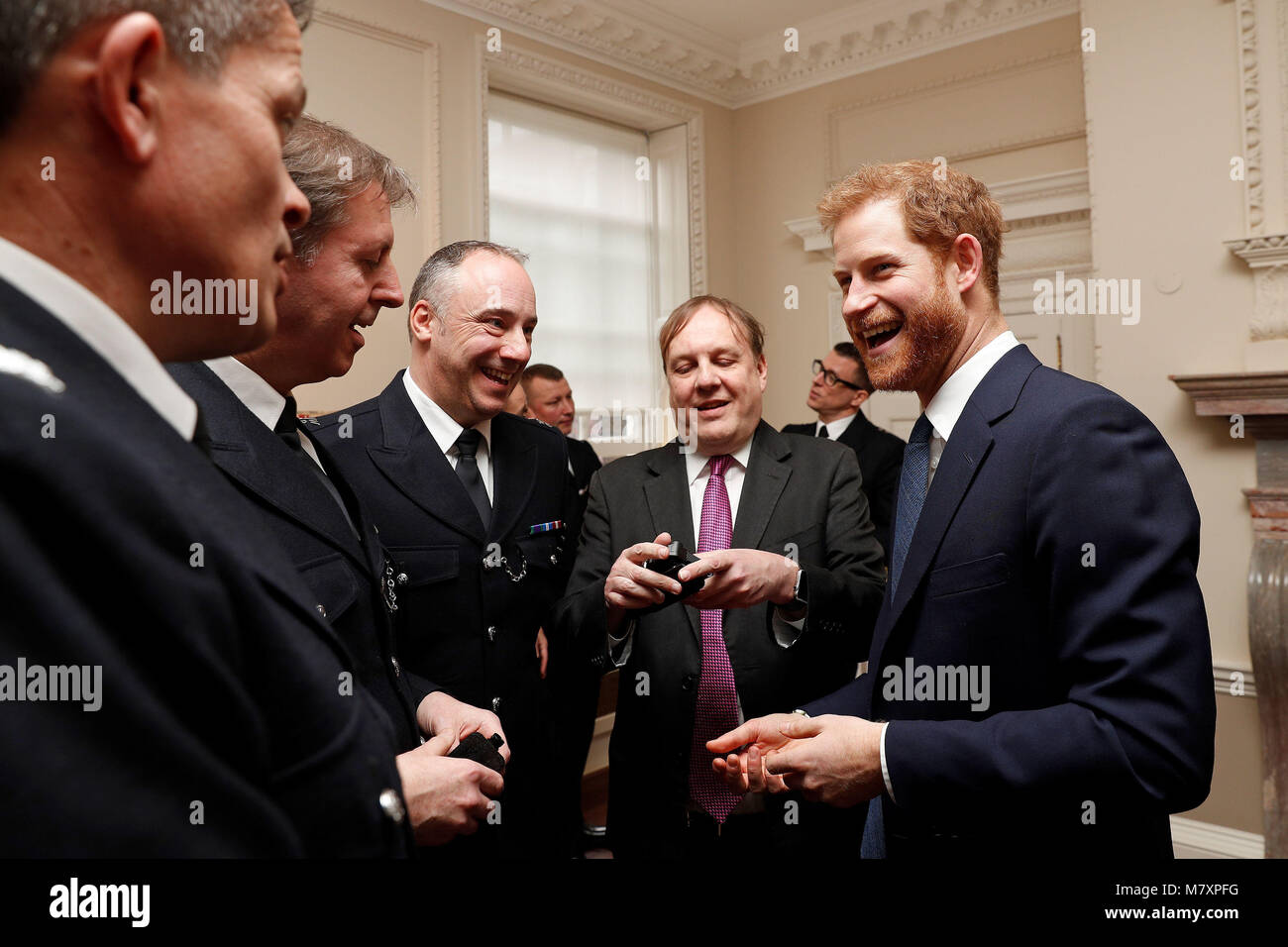 Prince Harry (right) meets police officers, staff and volunteers ...