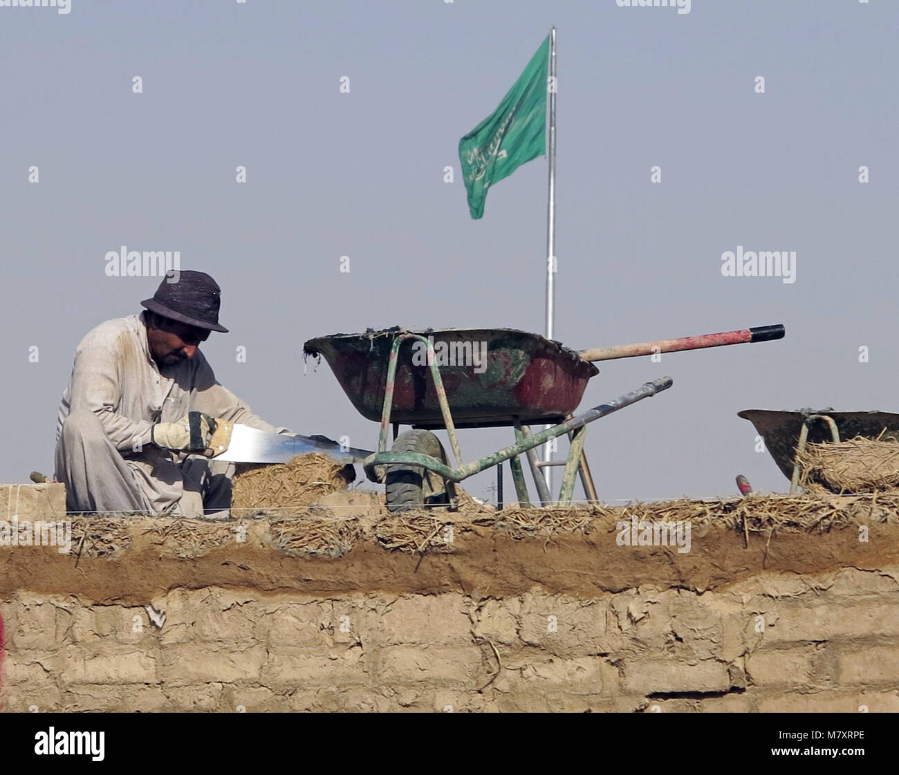 worker, refurbishing an old palace made of adobe and earth in Diriyya ...