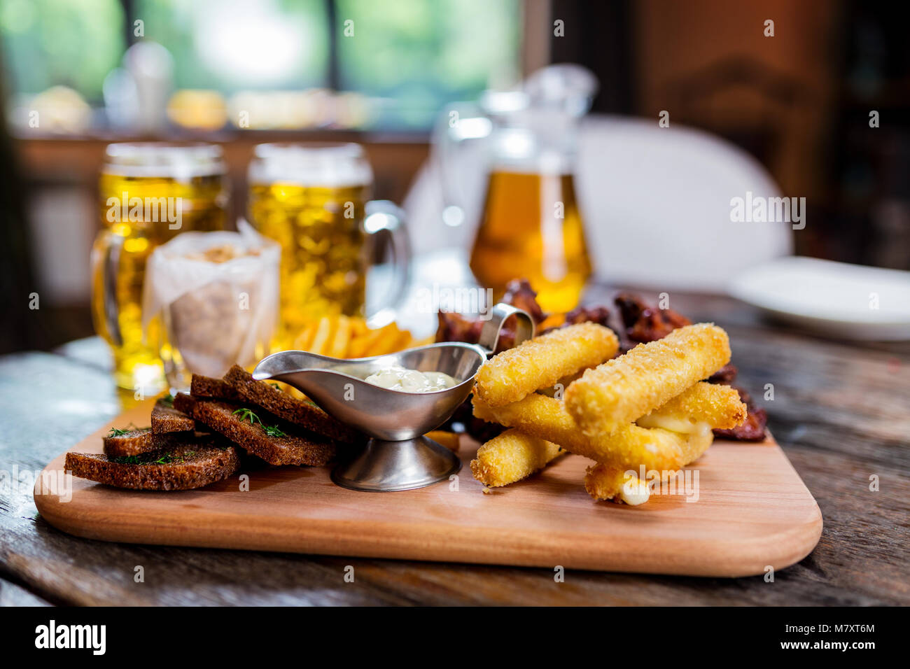 Assorted beer snacks with beer mugs Stock Photo - Alamy