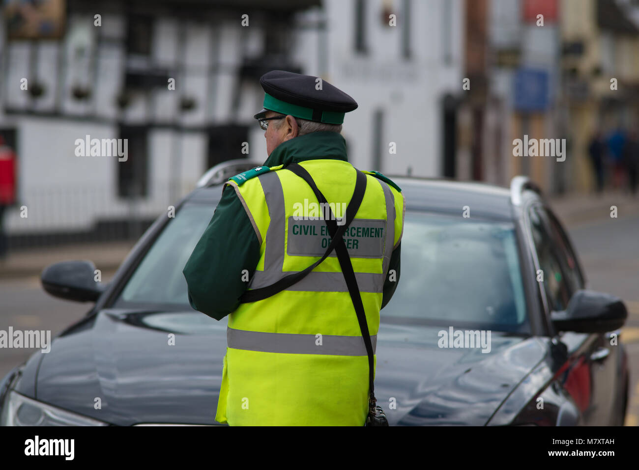 traffic warden in uniform issues fixed penalty notice tickets to ...