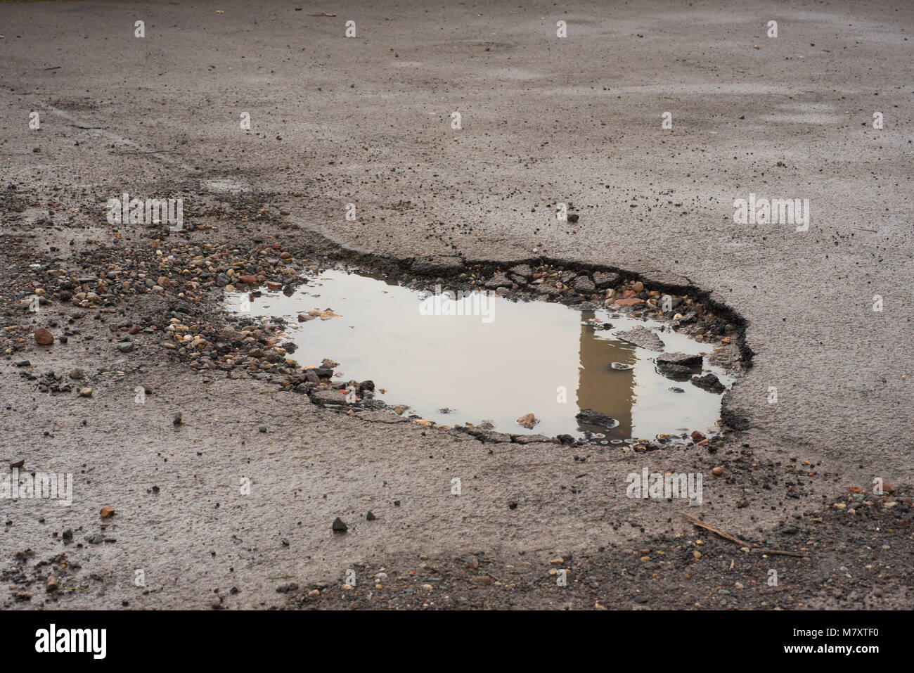 large potholes full of rainwater on English roads Stock Photo - Alamy