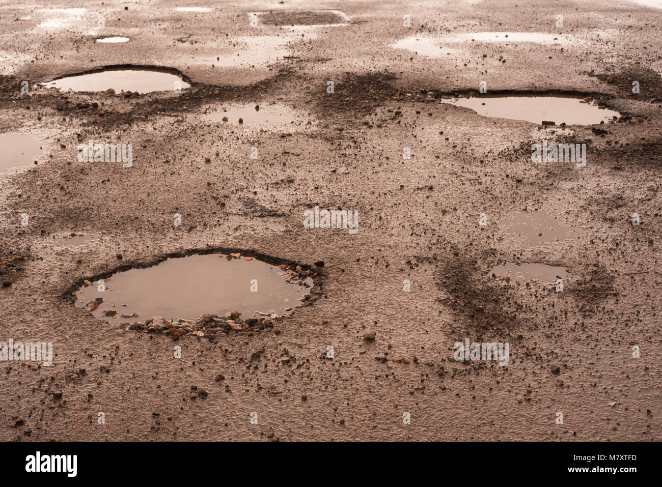 large potholes full of rainwater on English roads Stock Photo - Alamy