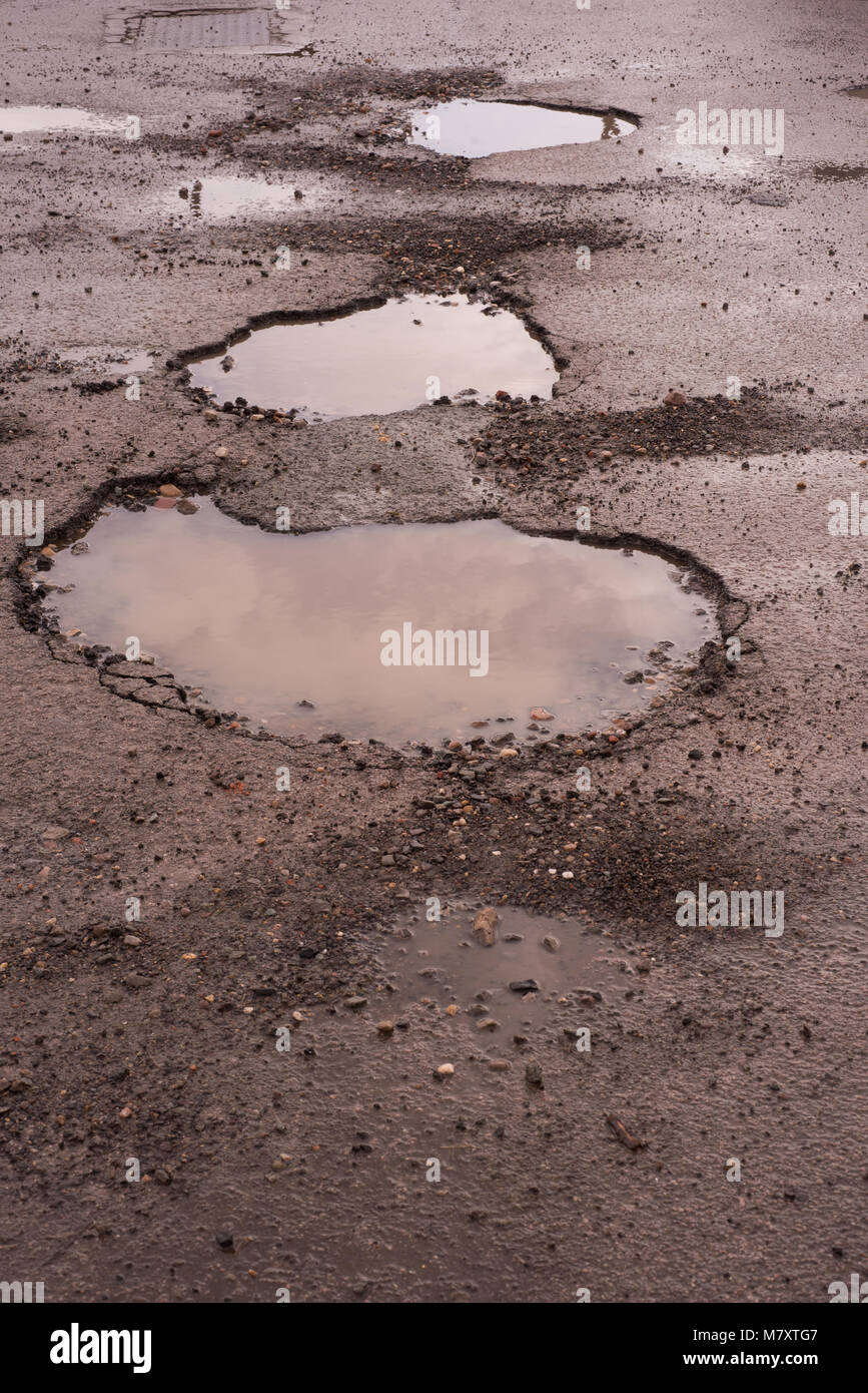 large potholes full of rainwater on English roads Stock Photo - Alamy