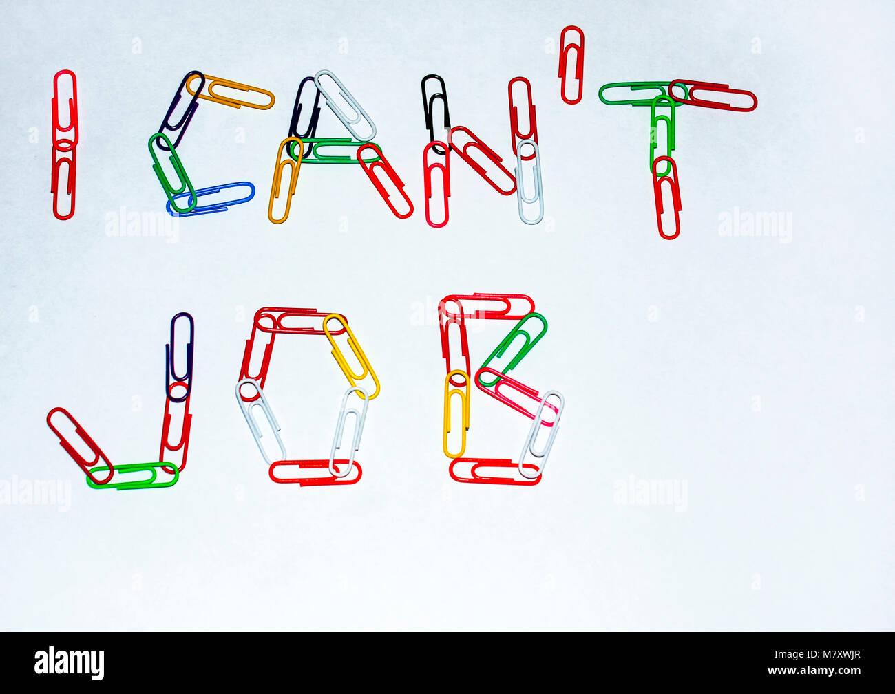 Concept. Words are laid out on a white sheet of paper with paper clips ...