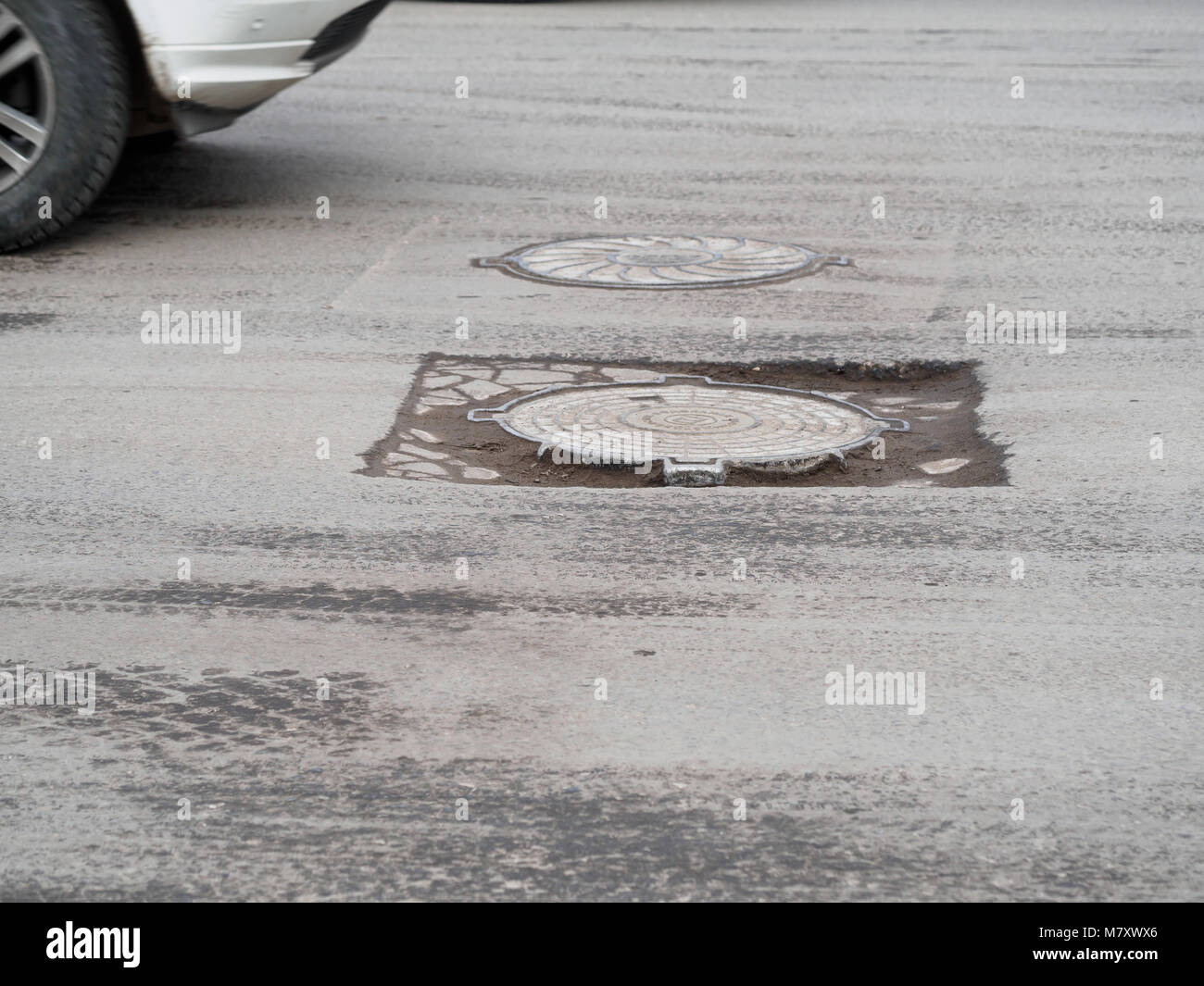 Deep pit on the road in russian town Stock Photo - Alamy
