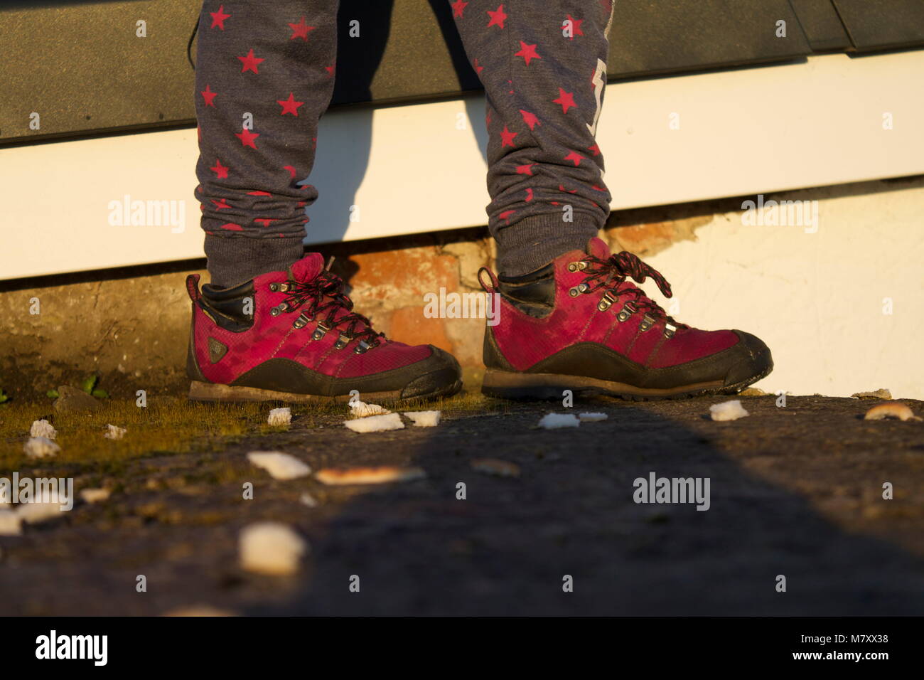 Sunrise shining onto her boots Stock Photo - Alamy