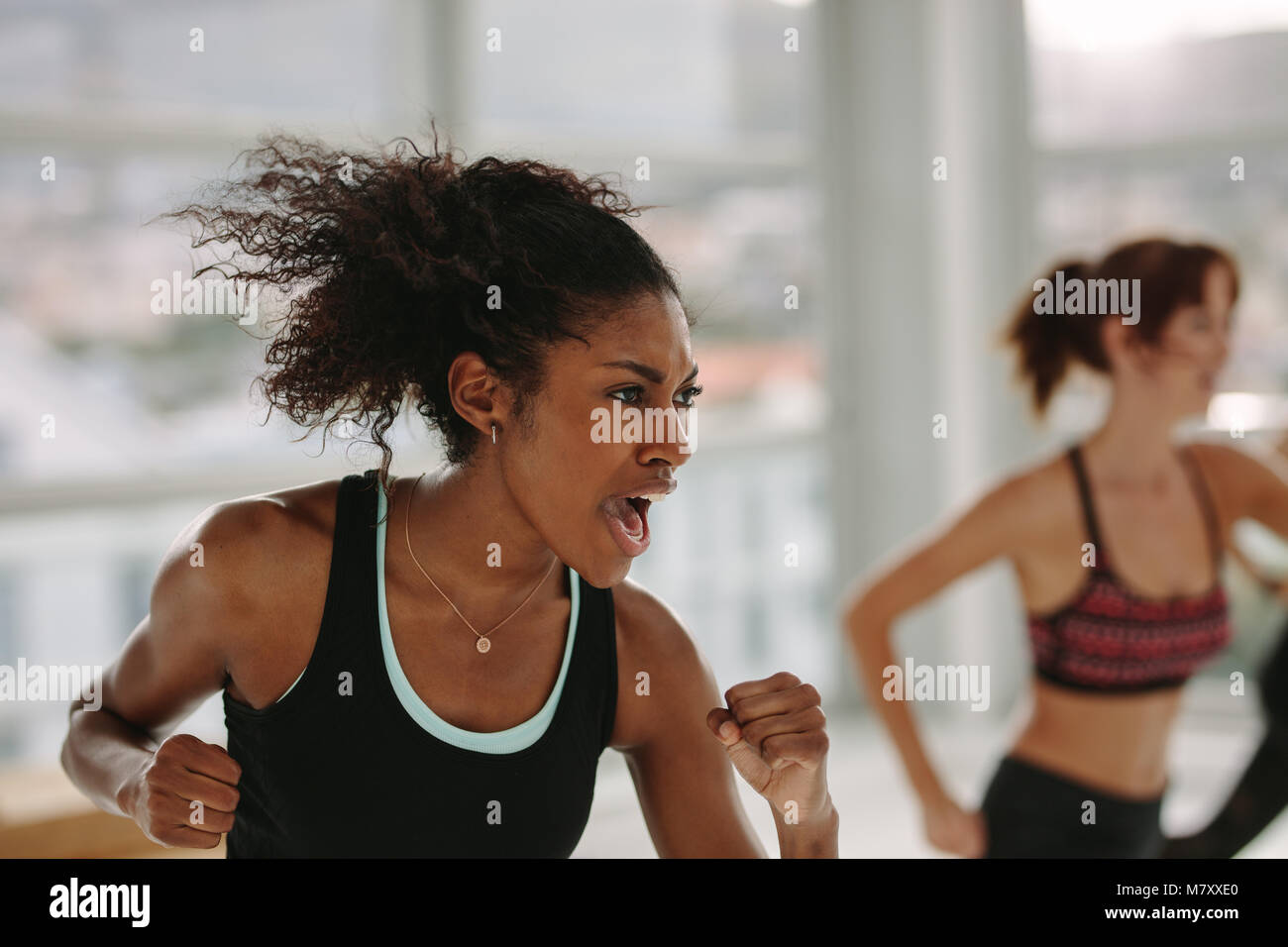 Intense fitness training in gym. Woman working out with full strength ...