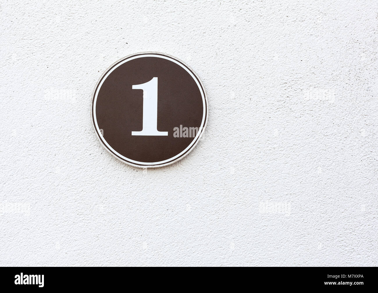 Round plate with number one is on a white wall, copyspace Stock Photo ...