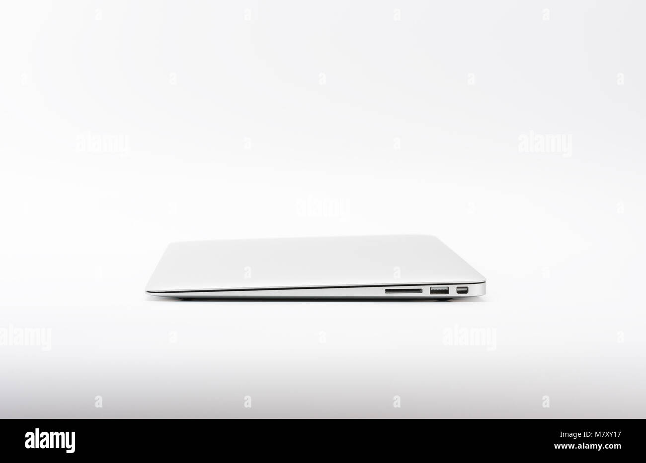 Closed modern, new laptop on white background, side view Stock Photo ...