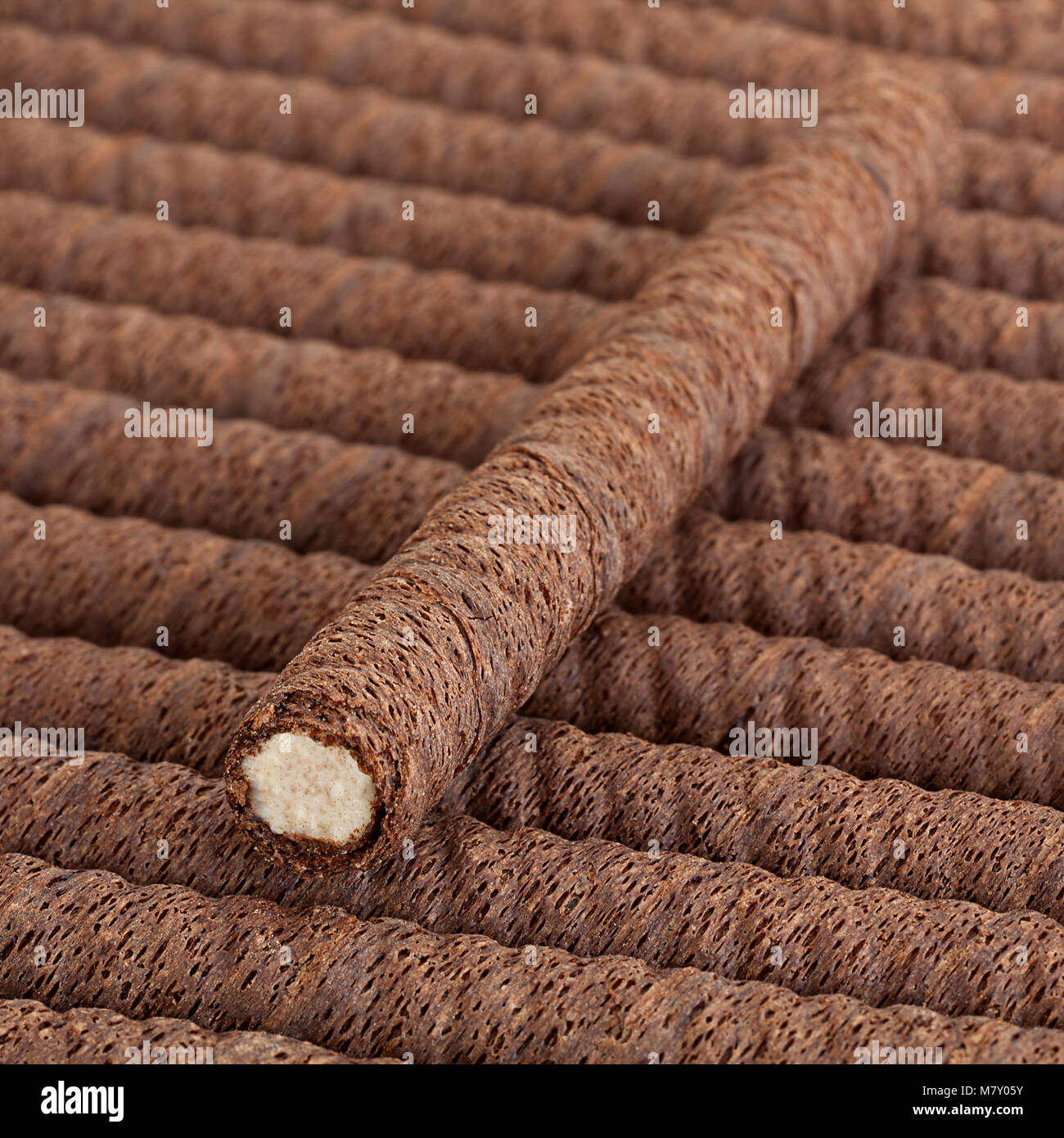 Waffle chocolate rolls stick closeup background Stock Photo - Alamy