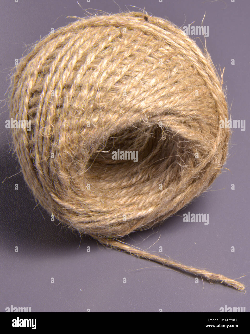 Jute string, roll rope on gray background Stock Photo - Alamy