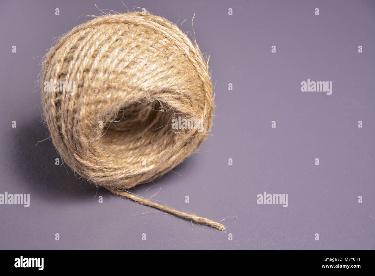 Jute string, roll rope on gray background Stock Photo - Alamy