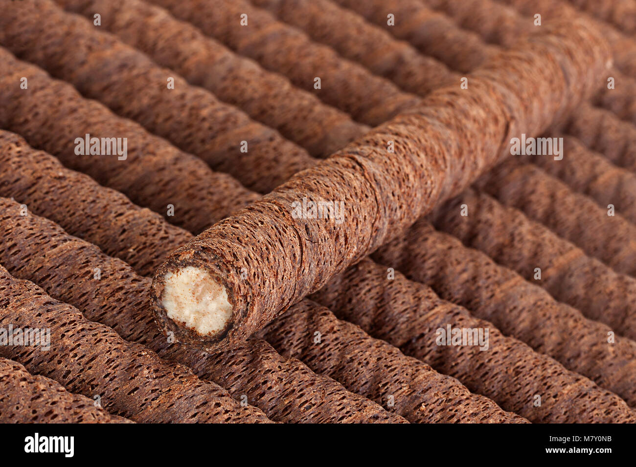 Waffle chocolate rolls stick closeup background Stock Photo - Alamy