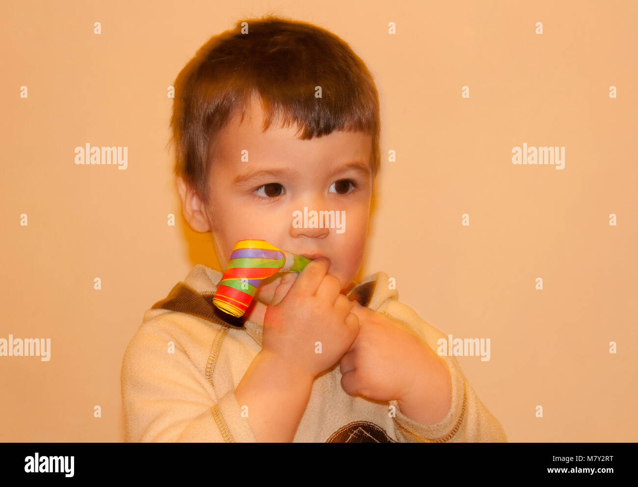 Blurred focus of an adorable boy's face with horn blower Stock Photo ...