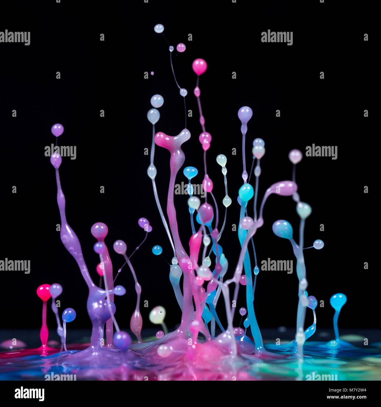 explosion of splashes and bursts of colour fluid paint or ink on a ...