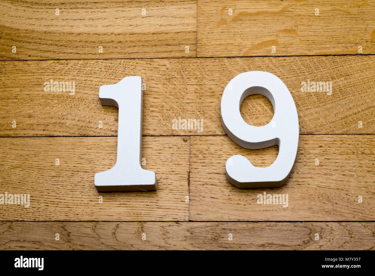 Number nineteen on a wooden, parquet floor as a background Stock Photo ...