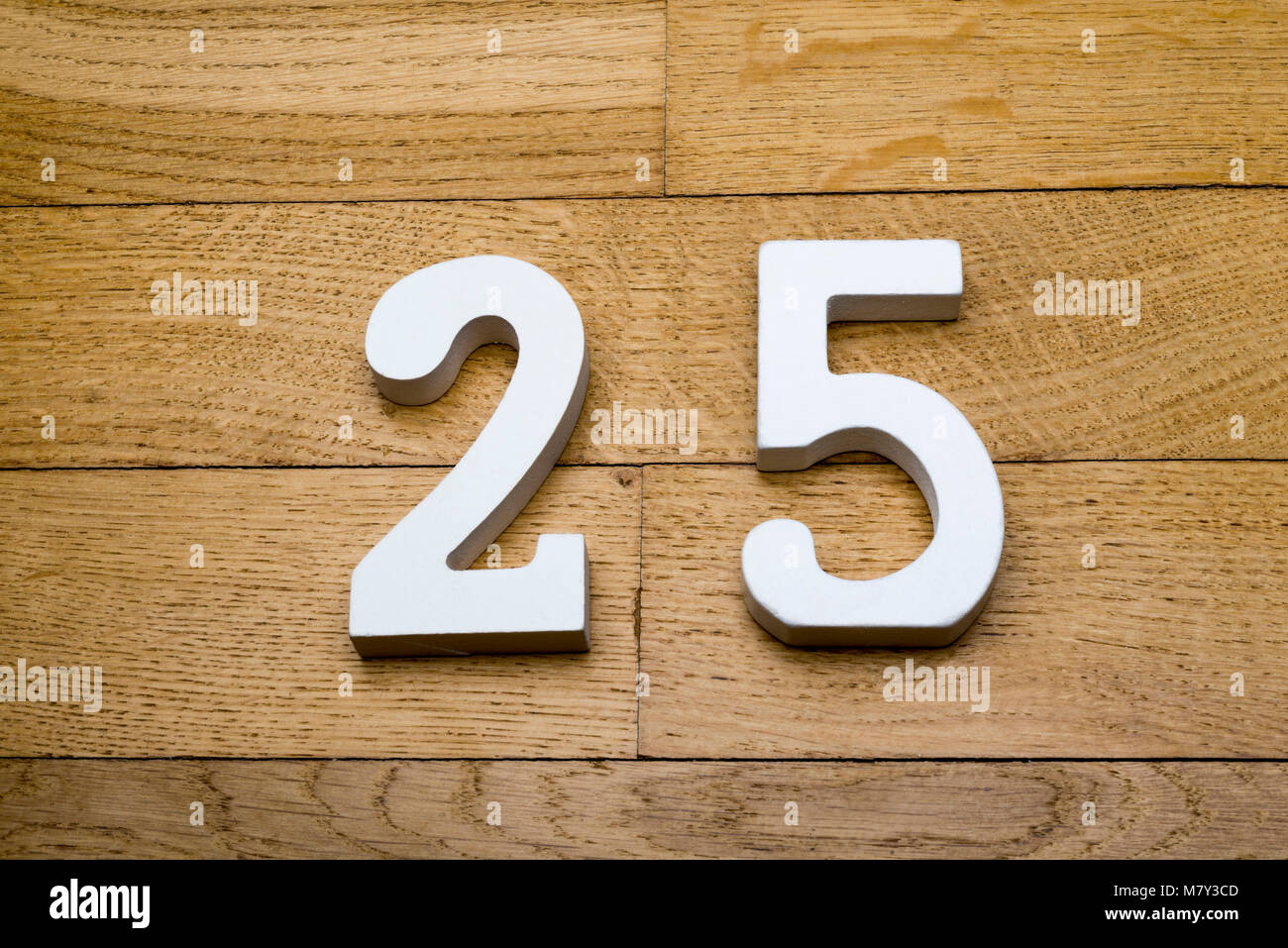 Figure twenty-five on a wooden, parquet floor as a background Stock ...