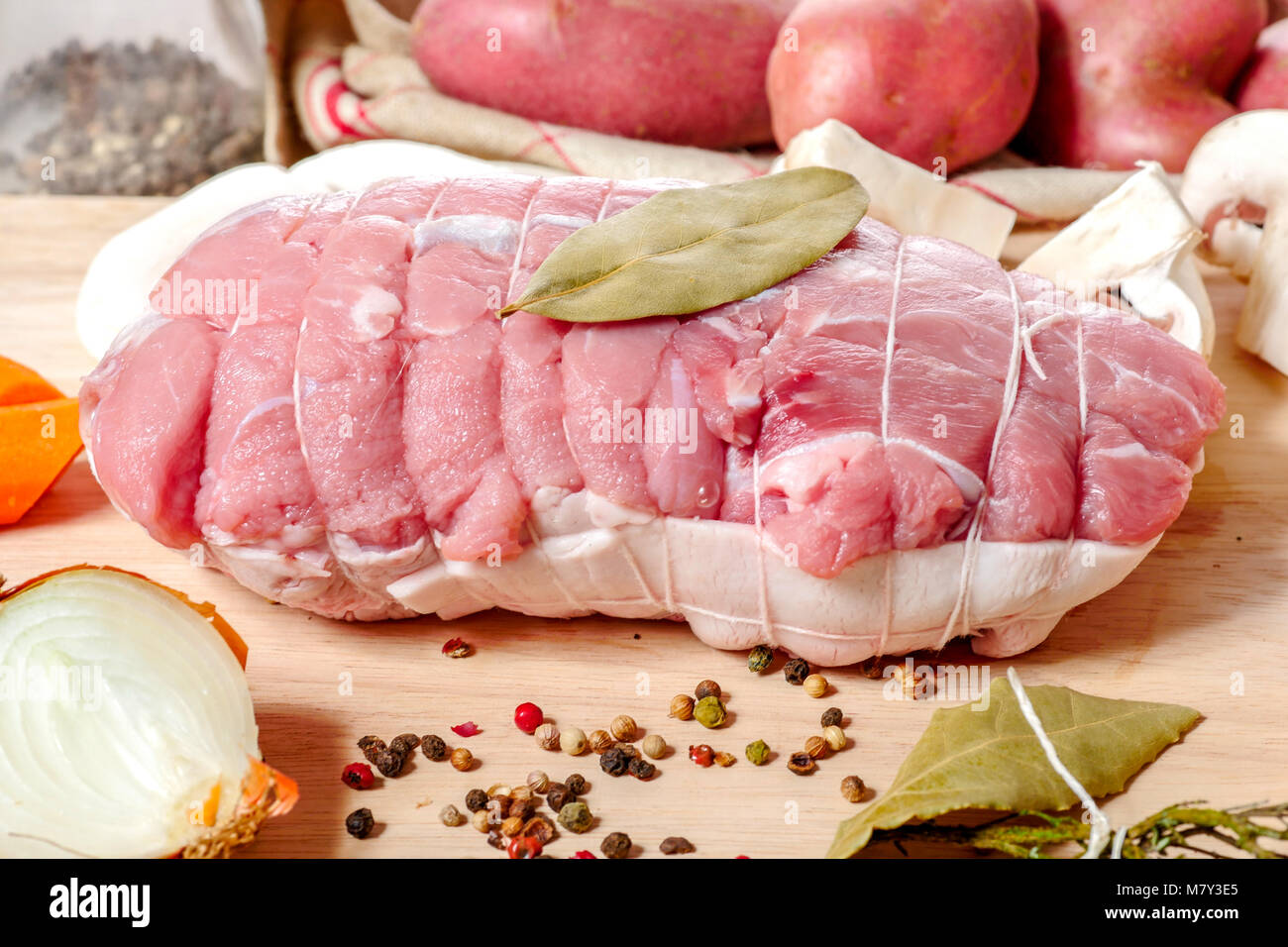 preparation of uncooked roast pork with the mushrooms Stock Photo - Alamy