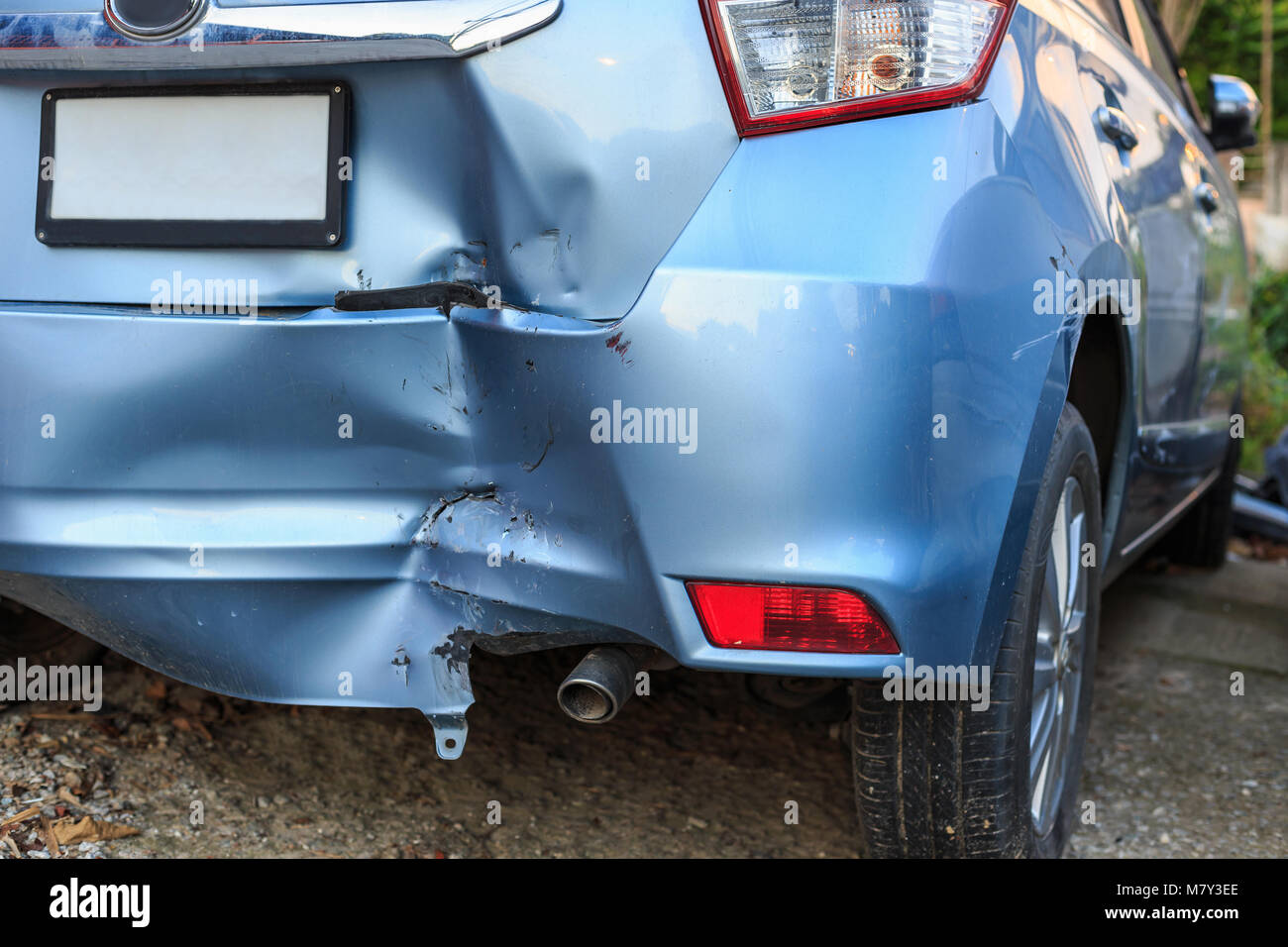 Backside of blue car get damaged by accident Stock Photo - Alamy