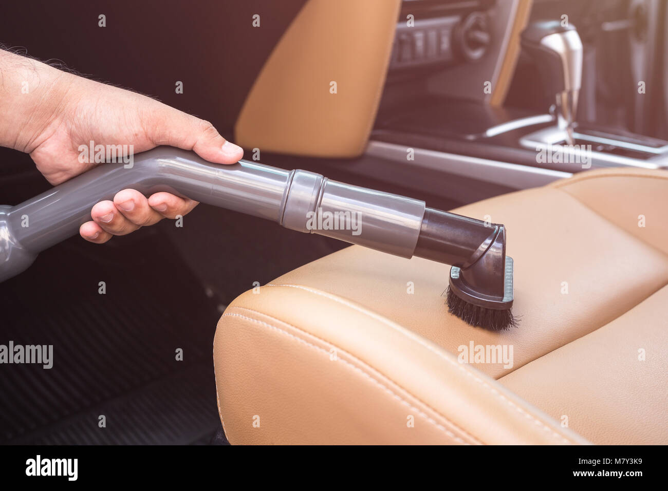 Close up hand of people holding vacuum cleaner and cleaning inside the ...
