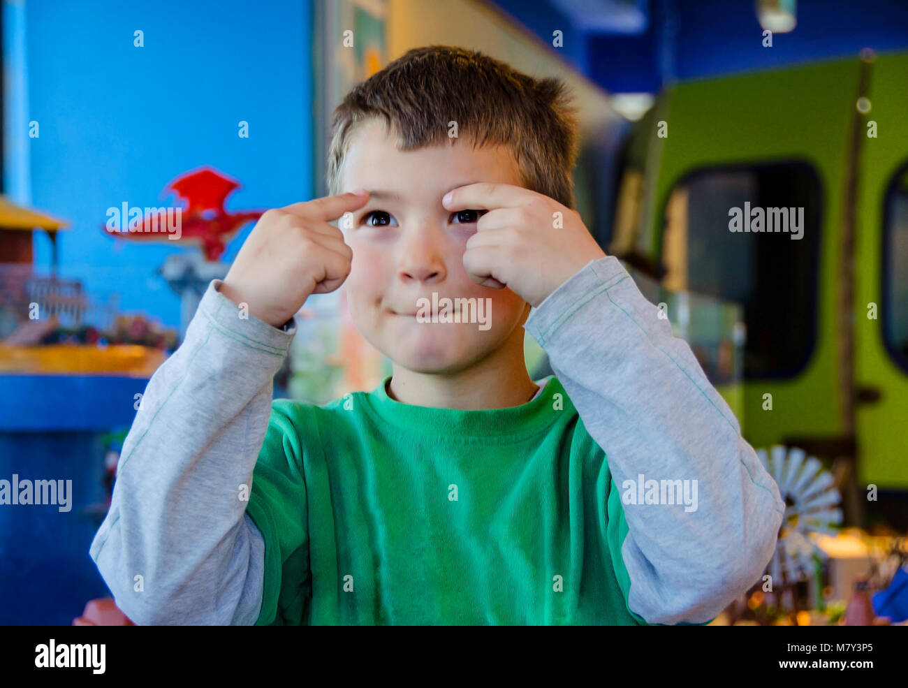 Lttle happy boy making gestures in his face Stock Photo - Alamy