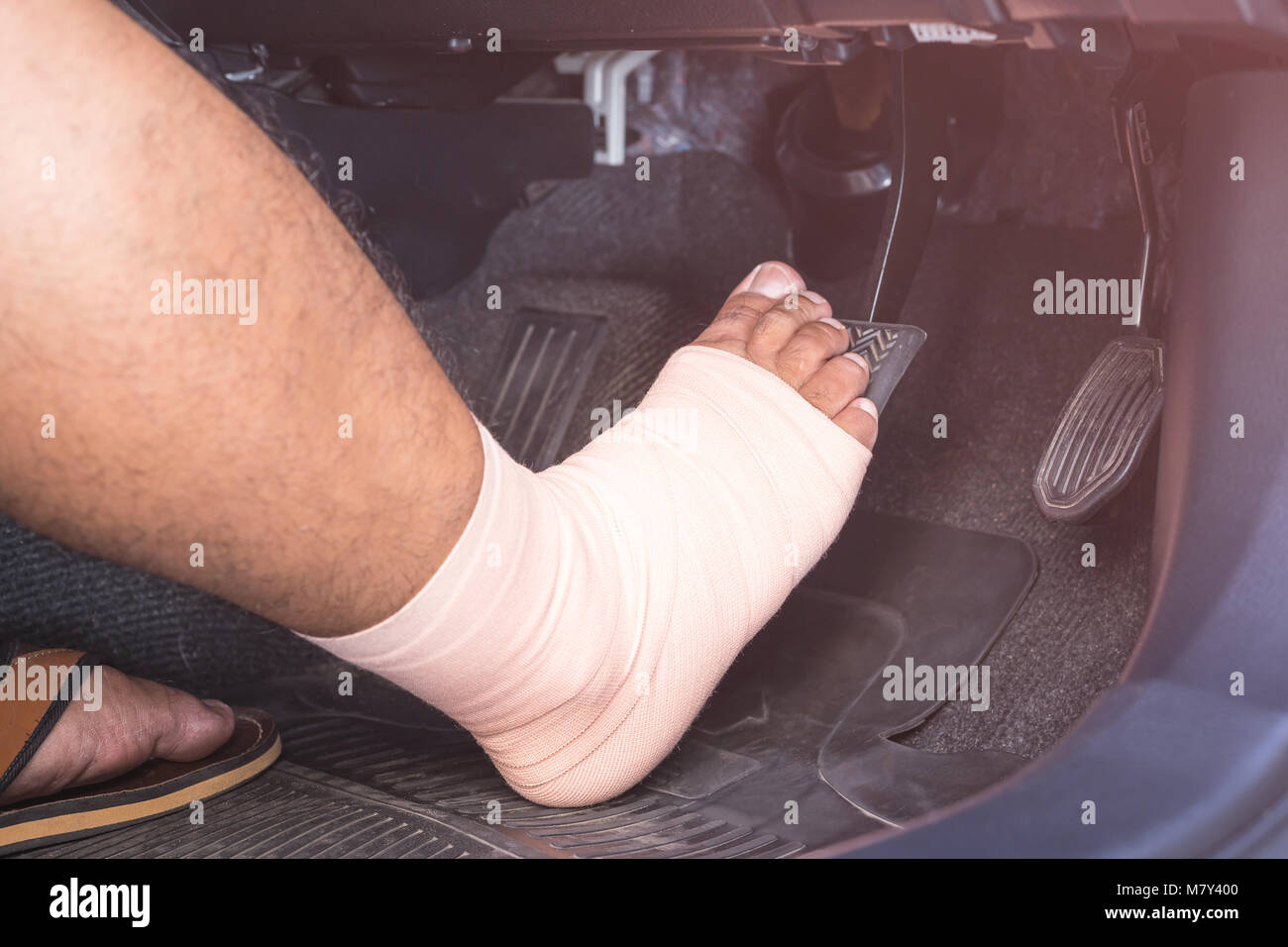 Close up right foot with bandage cloth step on the brakes in the modern ...