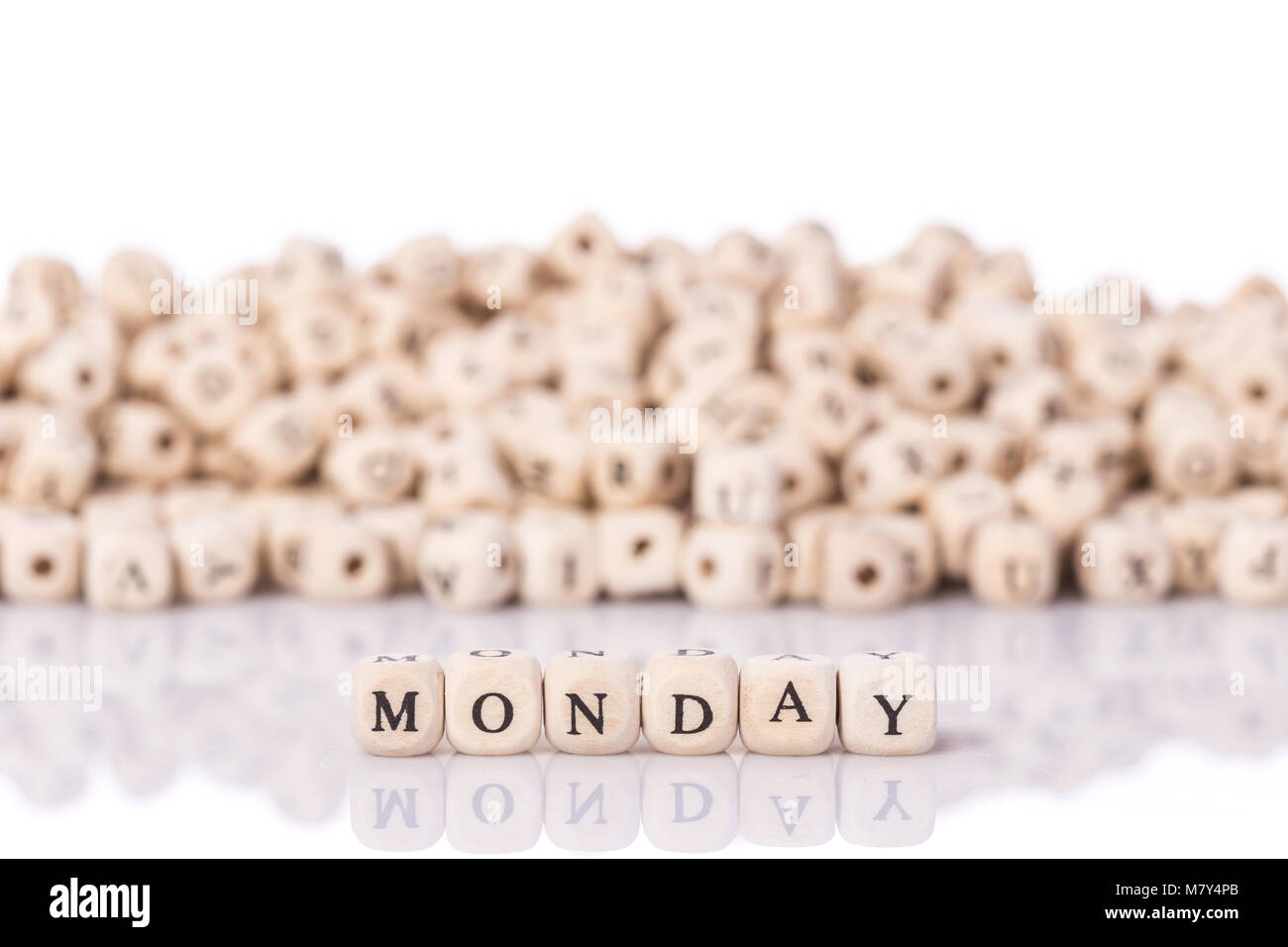 Macro word "MONDAY" writing in wooden alphabet. Studio shot isolated on ...