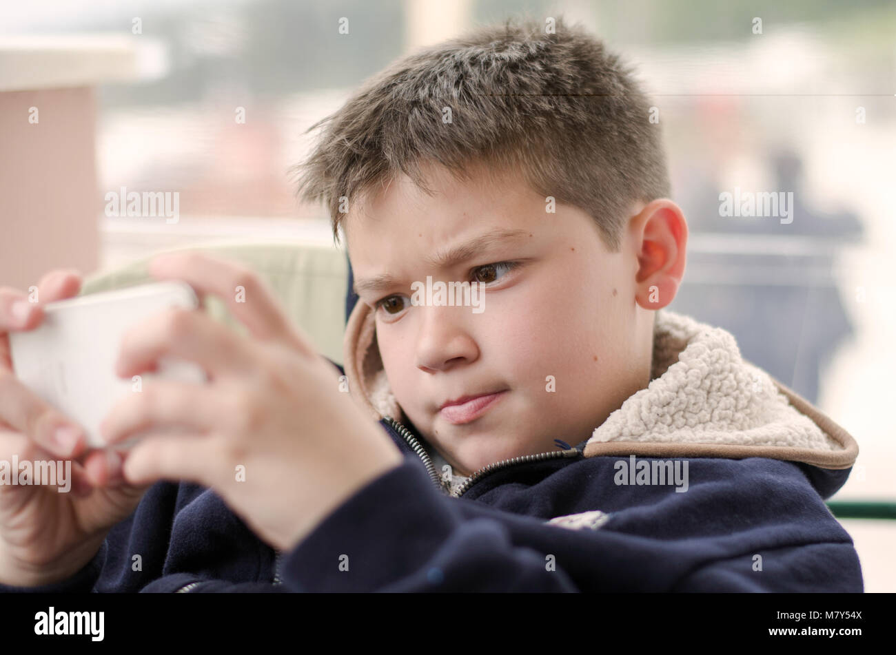 Boy kid child playing with mobile phone Stock Photo - Alamy
