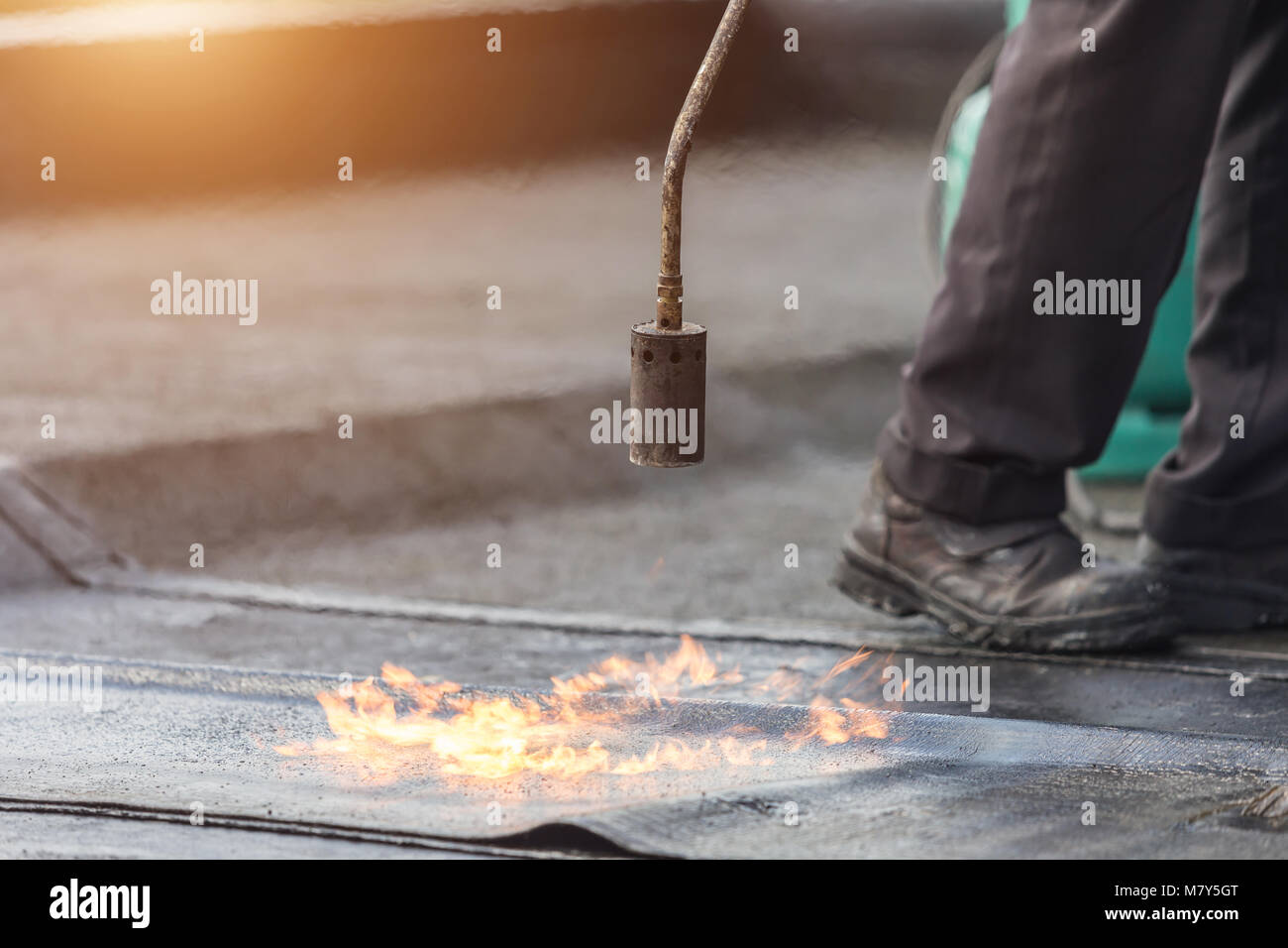 Asia worker installing tar foil on the rooftop of building. Waterproof ...